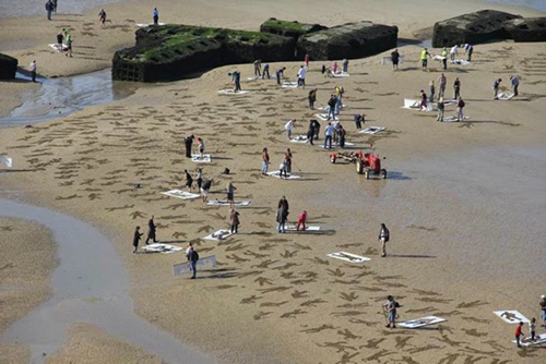 D-Day dead remembered in Normandy via sand display